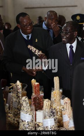 Zimbabwean President Robert Mugabe, center, arrives as he makes his ...
