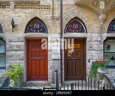 Upper West Side: Gothic-arched stained glass fan lights set in brick ...