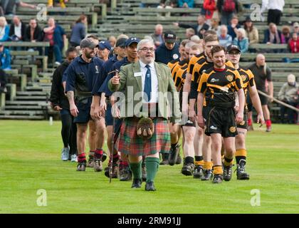 Tug of War teams entering the field, Braemar Highland Games, Scotland ...