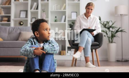 Disappointed little child in the psychologist office. Portrait of ...