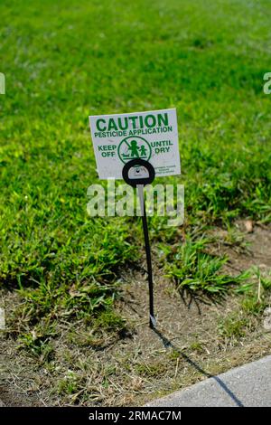 Caution pesticide application keep off sign on the chemically treated ...