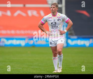 Tom Holroyd #18 of Leeds Rhinos offloads the ball during the Betfred ...