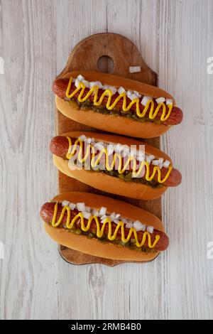 Char Grilled Hot Dog with Mustard, Relish and Onion on a rustic wooden ...