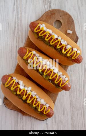 Char Grilled Hot Dog with Mustard, Relish and Onion on a rustic wooden ...