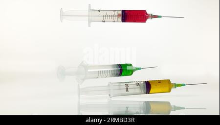 Syringe Falling against White Background Stock Photo - Alamy