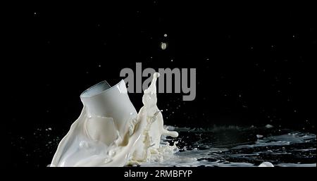 Glass of Milk Exploding against White Background Stock Photo - Alamy