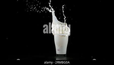 Glass of Milk Exploding against White Background Stock Photo - Alamy