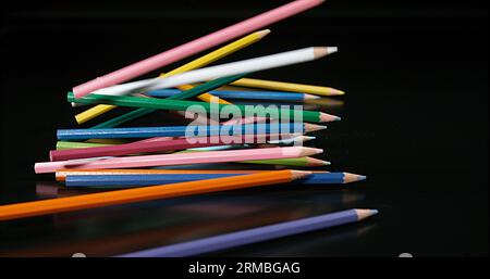 Color crayons falling against Black Background Stock Photo - Alamy