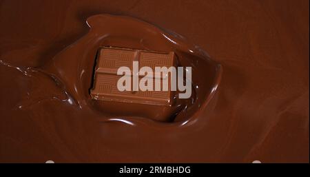 Chocolate tablet falling into Milk Chocolate Stock Photo - Alamy