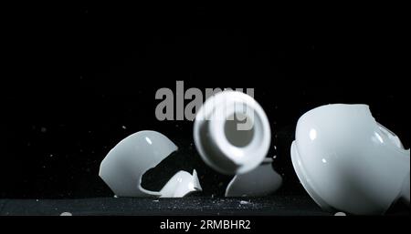 Tea-Pot falling and exploding on Black Background Stock Photo - Alamy