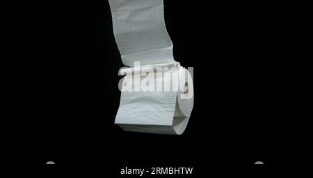 Roll of Toilet Paper Falling on Black Background Stock Photo - Alamy