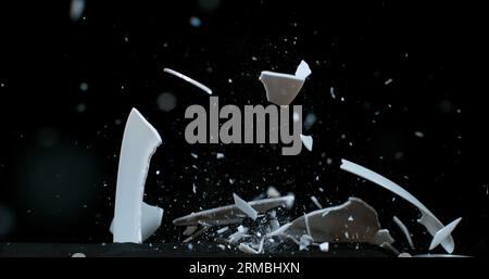Plate falling and exploding on Black Background Stock Photo - Alamy