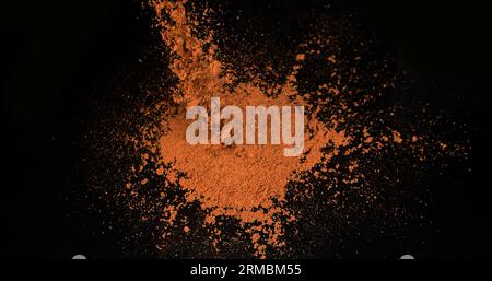 Paprika, capsicum annuum, Powder Exploding against black Background ...