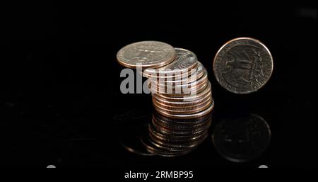 Quarter Dollar Coins Falling, Rolling and Sliding on Black Background ...