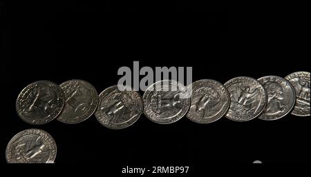 Quarter Dollar Coins Falling, Rolling and Sliding on Black Background ...