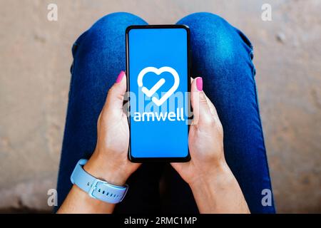 In this photo illustration, the Amwell logo seen displayed on a ...