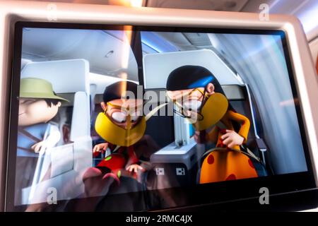 Personal television, PTV in front of an airplane seat showing instructions on putting a mask to ...