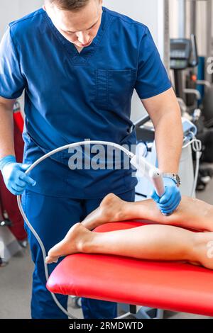 Physical therapy of the shin with shock wave, extracorporeal shockwave ...
