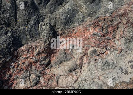 Bands of red laterite rock (iron from vegetation)in basaltic lava flow ...