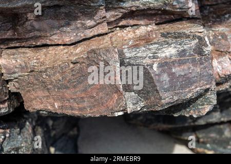 Bands of red laterite rock (iron from vegetation)in basaltic lava flow ...