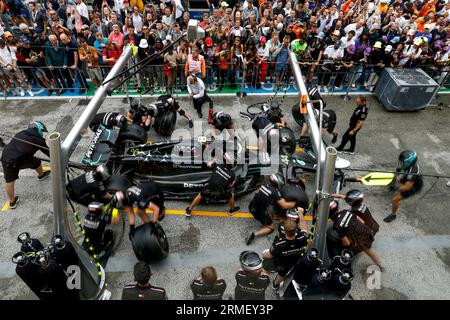 Mercedes pit crew members practice at the pits at the Suzuka Circuit in ...
