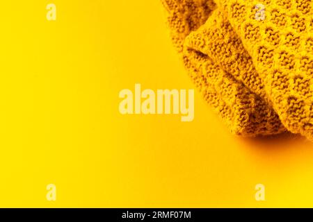 Micro close up of yellow wooly crochet fabric with copy space on yellow ...