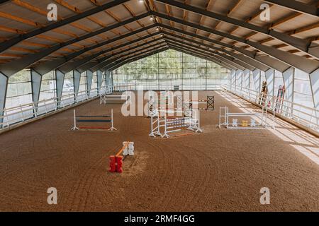 View of empty indoor riding paddock Stock Photo - Alamy