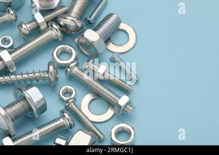 Many different fasteners on light blue background, closeup Stock Photo ...
