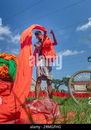 Dyed clothes of different colors are dried in the sun Stock Photo - Alamy