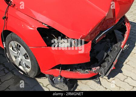 Crashed car of red color. Side view of the wrecked vehicle. The car ...
