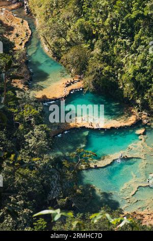 Tourists swim and enjoy the turquoise pools on the Cahabón River in ...