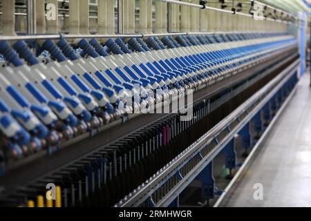 Machinery and equipment in operation in spinning mill Stock Photo - Alamy