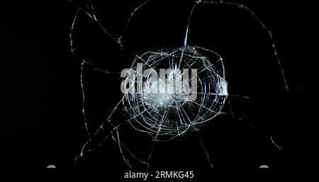 Golf Ball breaking Pane of Glass against Black Background Stock Photo ...