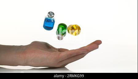 Medical Product Falling into Hand against White Background Stock Photo ...