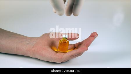 Medical Product Falling into Hand against White Background Stock Photo ...
