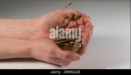 Euro Coins Falling into Hands of Woman against White Background Stock ...