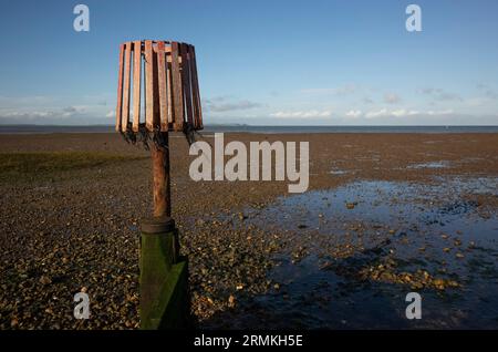 Faded red high tide maker on a beach in Whitstable Kent UK Stock Photo ...