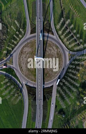 Aerial zenithal view of a roundabout with an arch of the suspension ...