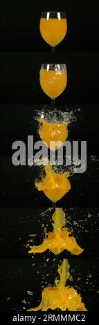 Glass of Orange Exploding against Black Background Stock Photo - Alamy
