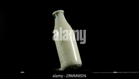 Bottle of Milk Exploding against Black Background Stock Photo - Alamy