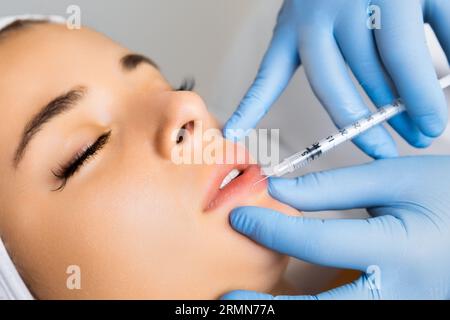 Close up of cosmetic botox injection in female lips. Front view of ...