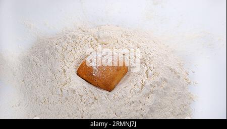 Bread Falling in Flour against White Background Stock Photo - Alamy