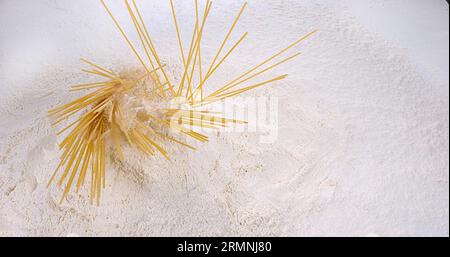 Pasta falling on flour against White Background Stock Photo - Alamy