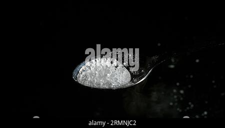 Drug, Cocaine in spoon against black background Stock Photo - Alamy