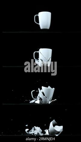 Cup falling and exploding on Black Background Stock Photo - Alamy