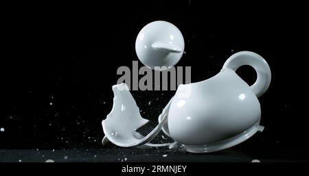 Tea-Pot falling and exploding on Black Background Stock Photo - Alamy