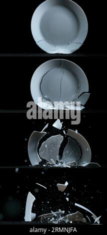 Plate falling and exploding on Black Background Stock Photo - Alamy