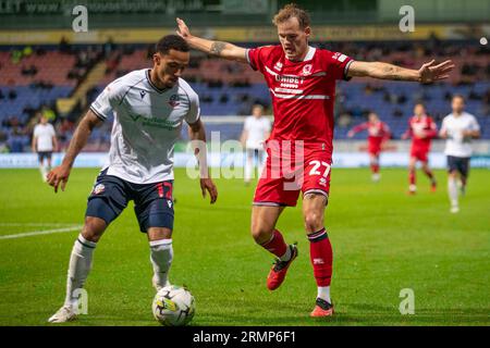Josh Dacres-Cogley #12 of Bolton Wanderers competes for the ball with ...