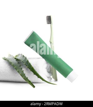 Tube of toothpaste, brush and aloe vera leaves on white background ...