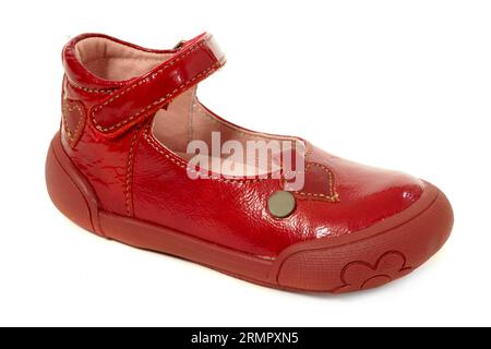 A red childs shoe. Taken on a clean white background Stock Photo - Alamy